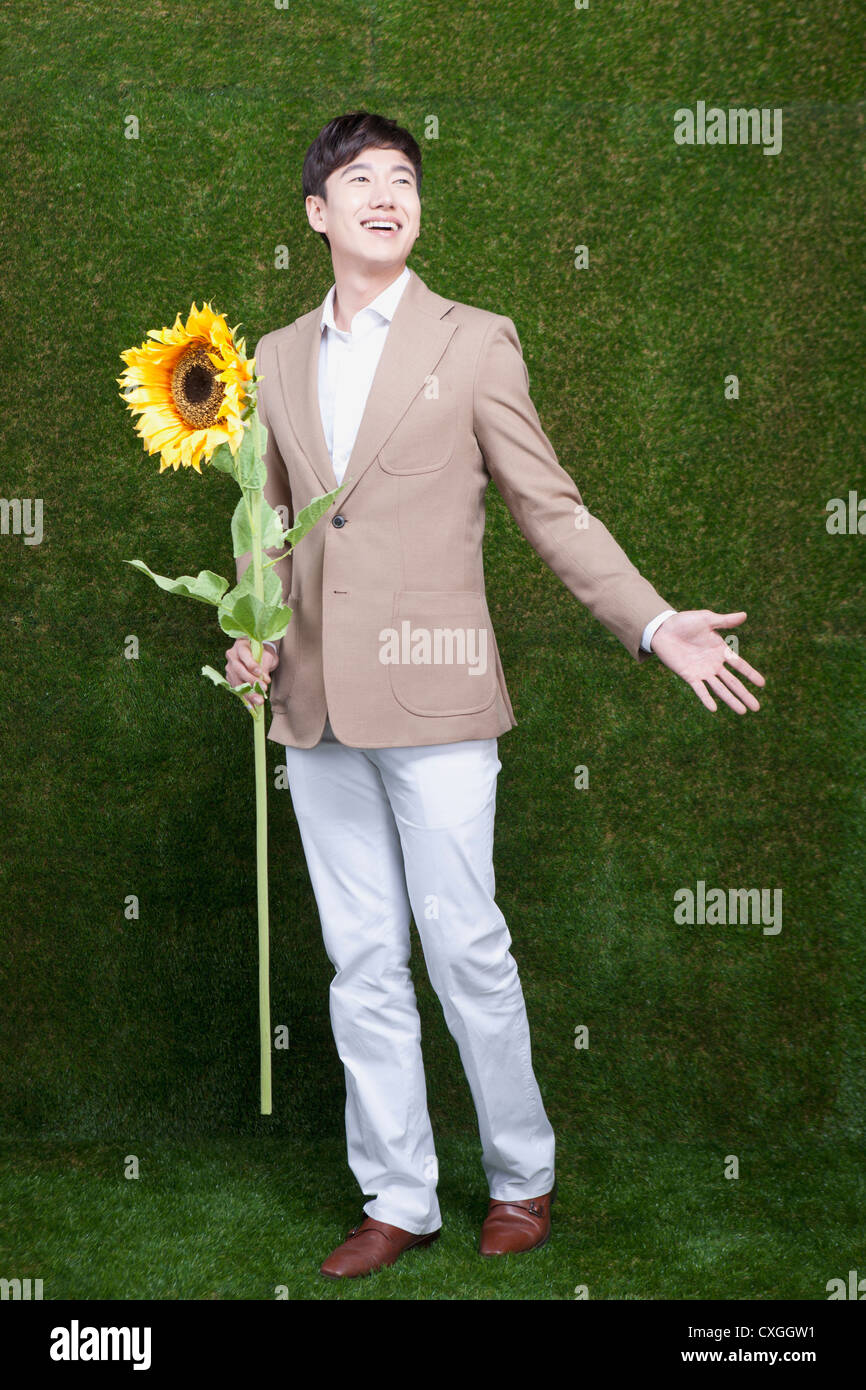 man holding a sunflower Stock Photo - Alamy