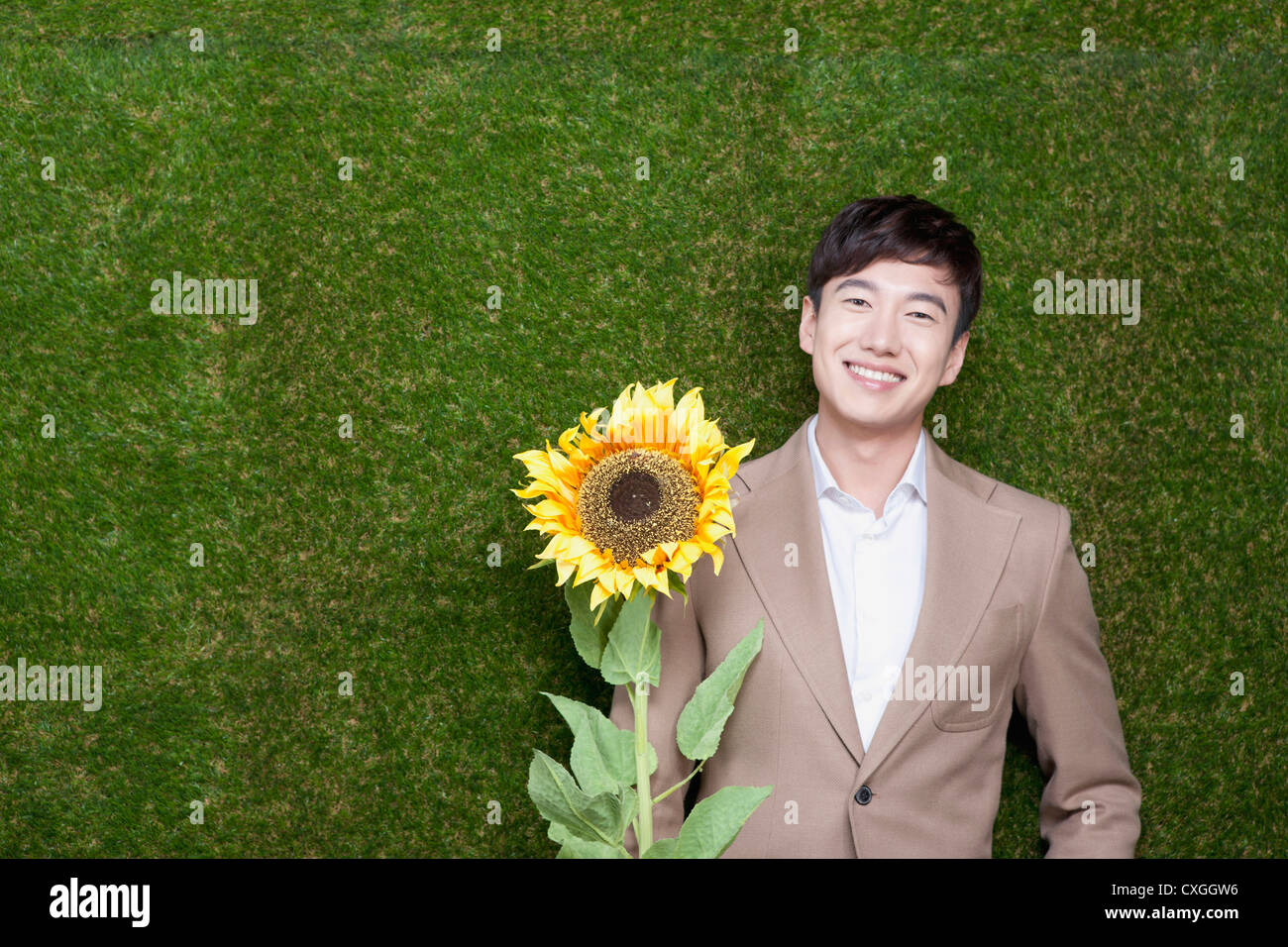 man holding a sunflower Stock Photo - Alamy