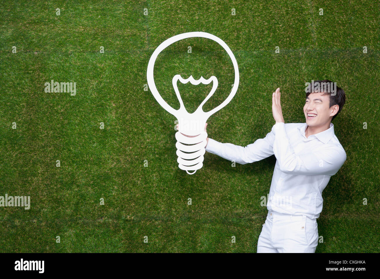 man holding a bulb on his hand Stock Photo - Alamy