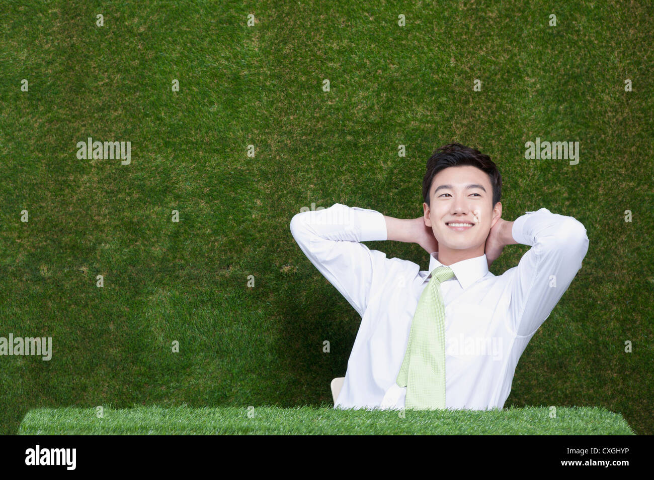 man sitting and leaning against the chair Stock Photo - Alamy