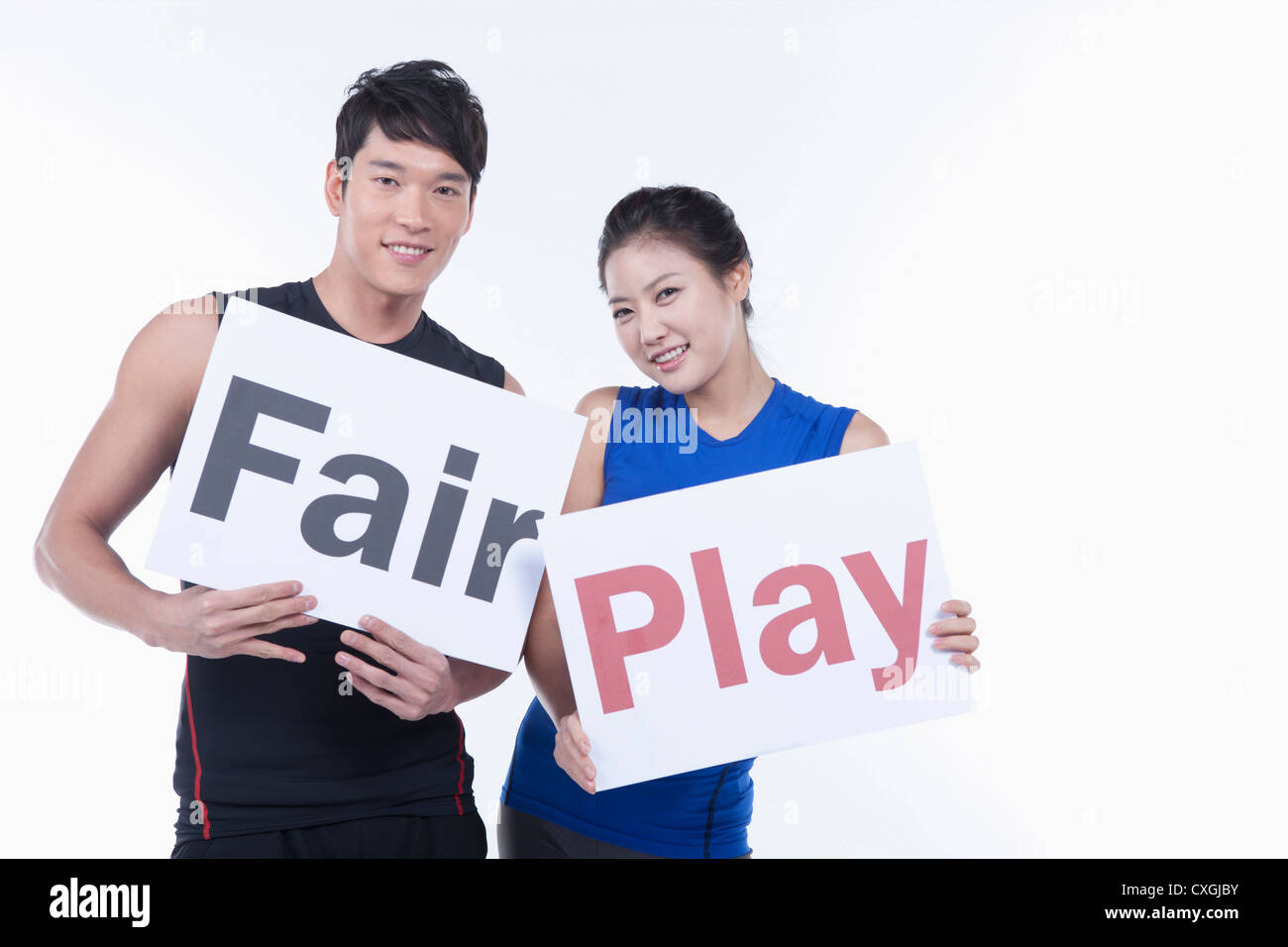 a couple of athletes holding a placard of Fair Play Stock Photo - Alamy