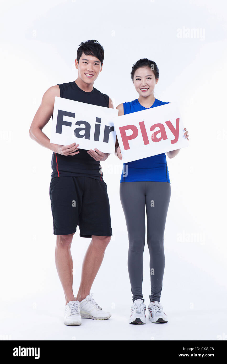 a couple of athletes holding a placard of Fair Play Stock Photo - Alamy