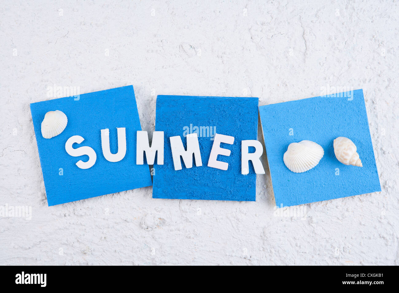 shells and letter blocks of SUMMER on the blue tiles Stock Photo - Alamy