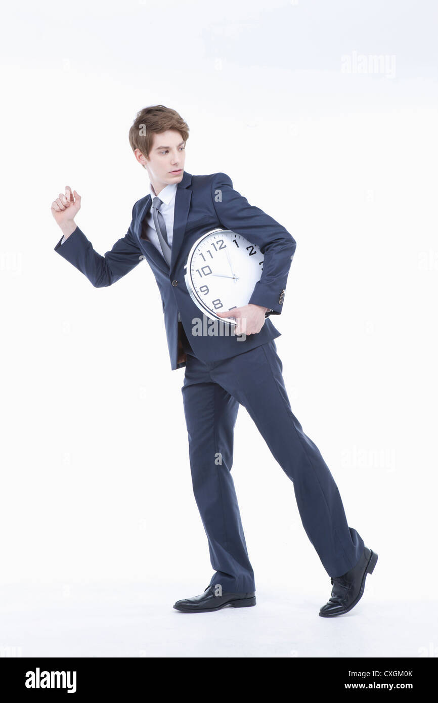 businessman carrying a clock Stock Photo - Alamy