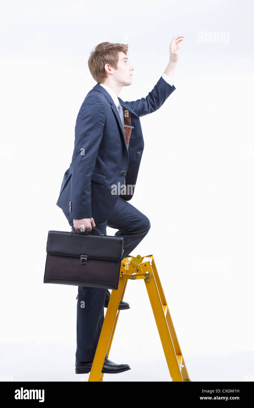 Man standing on ladder reaching hi-res stock photography and images - Alamy