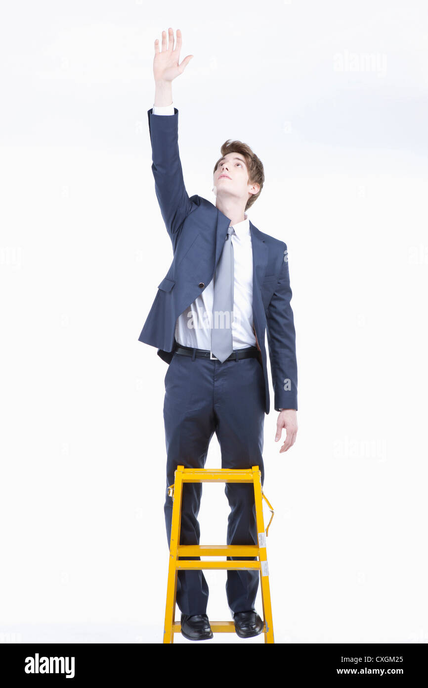 businessman reaching out his hand on the ladder Stock Photo - Alamy