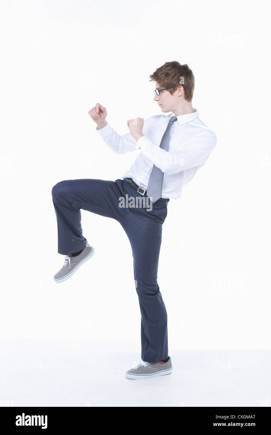 businessman bending his knee to kick Stock Photo - Alamy