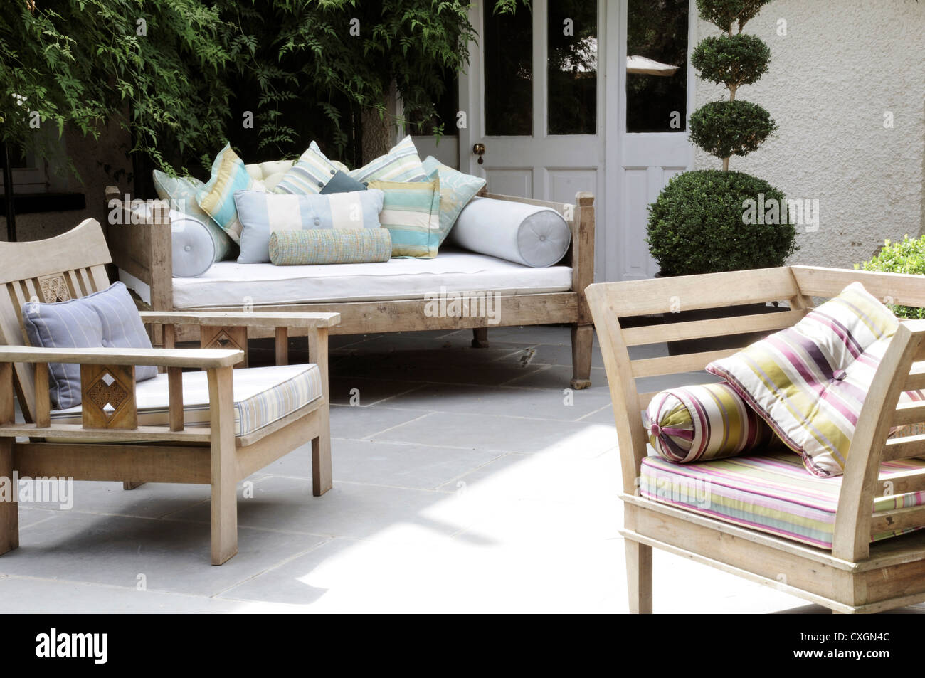 Outside seating area consisting of three different shaped chairs and ...