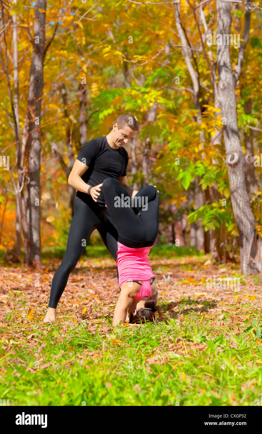Couple practice yoga in forest Stock Photo - Alamy