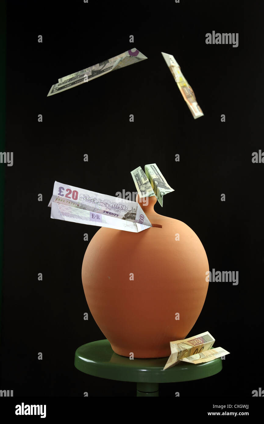 notes in form of paper airplane around a typical vintage money box ...