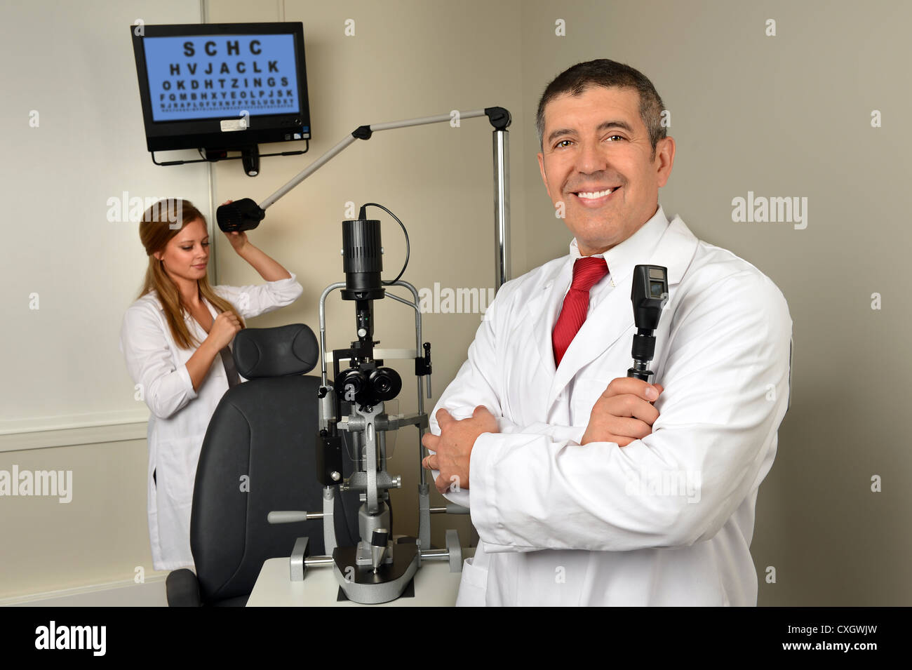 Hispanic eye doctor and female assistant in examination room Stock ...