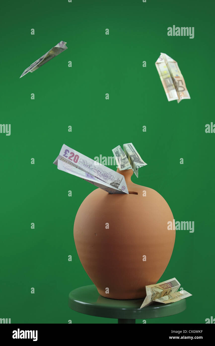 flying banknotes around a money box Stock Photo - Alamy