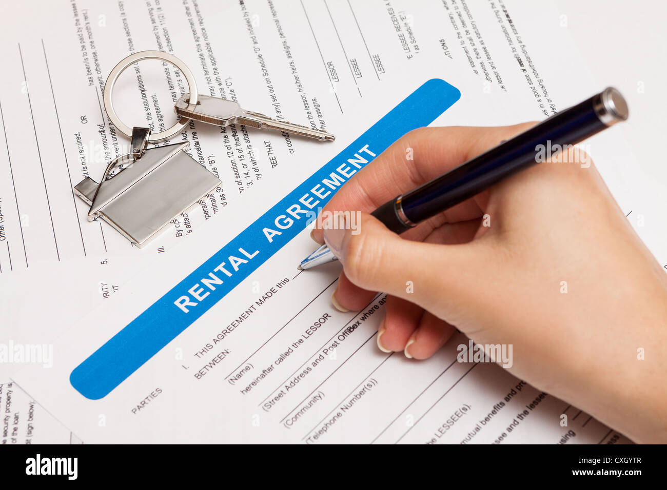 rental agreement form with signing hand and keys and pen Stock Photo ...