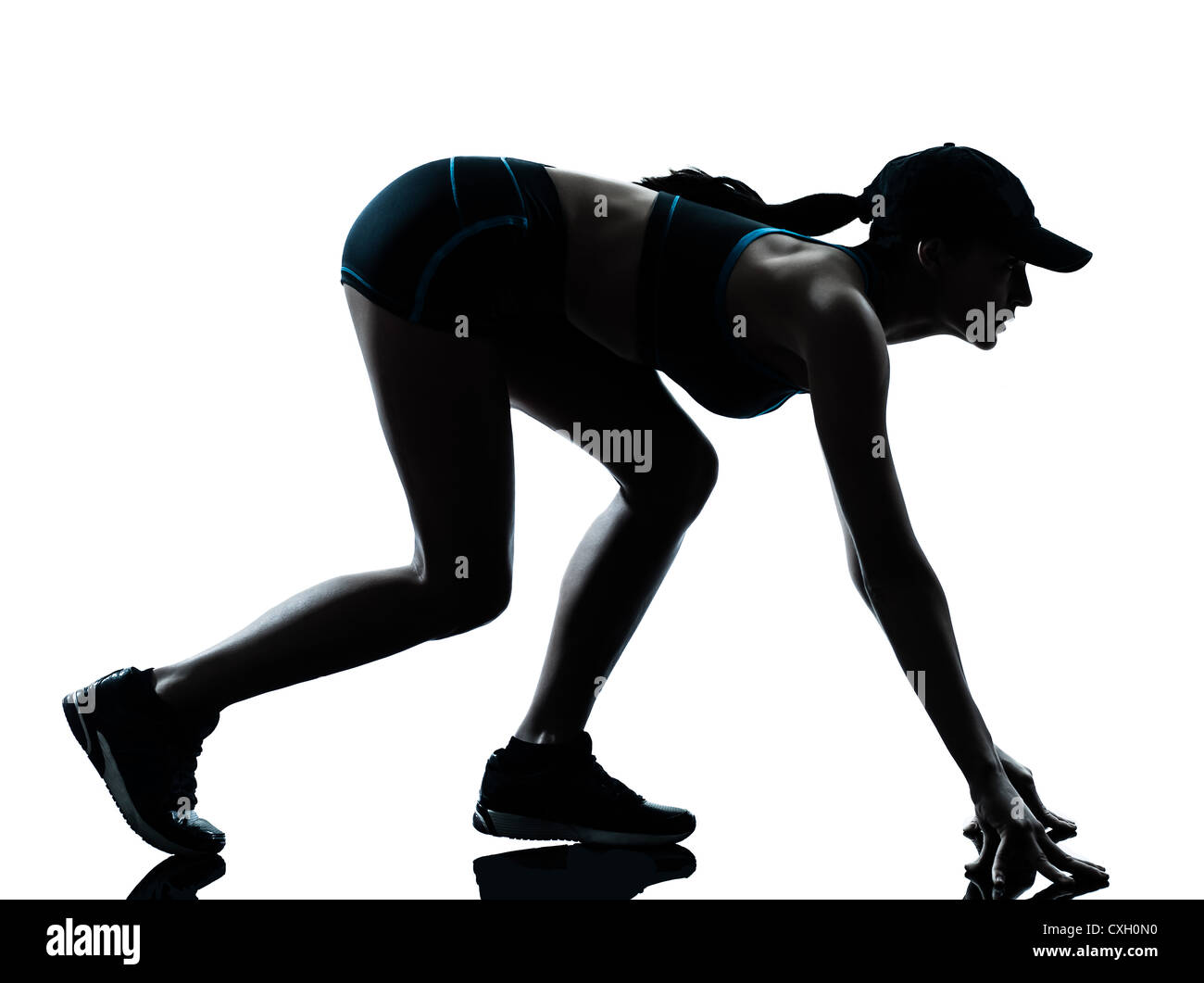 one caucasian woman runner jogger on the starting block in silhouette ...