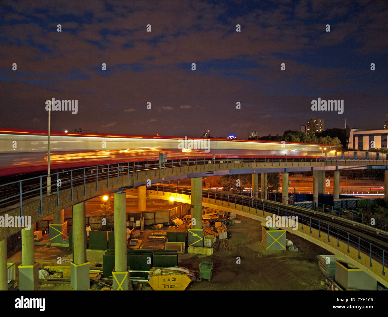 Night view of DLR train in transit, West India Quay, London, England ...