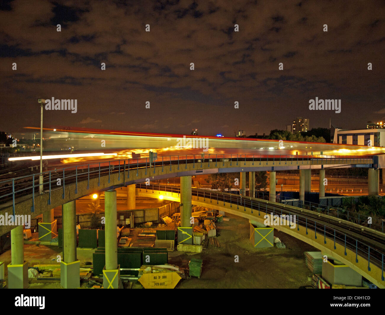 Night view of DLR train in transit, West India Quay, London, England ...