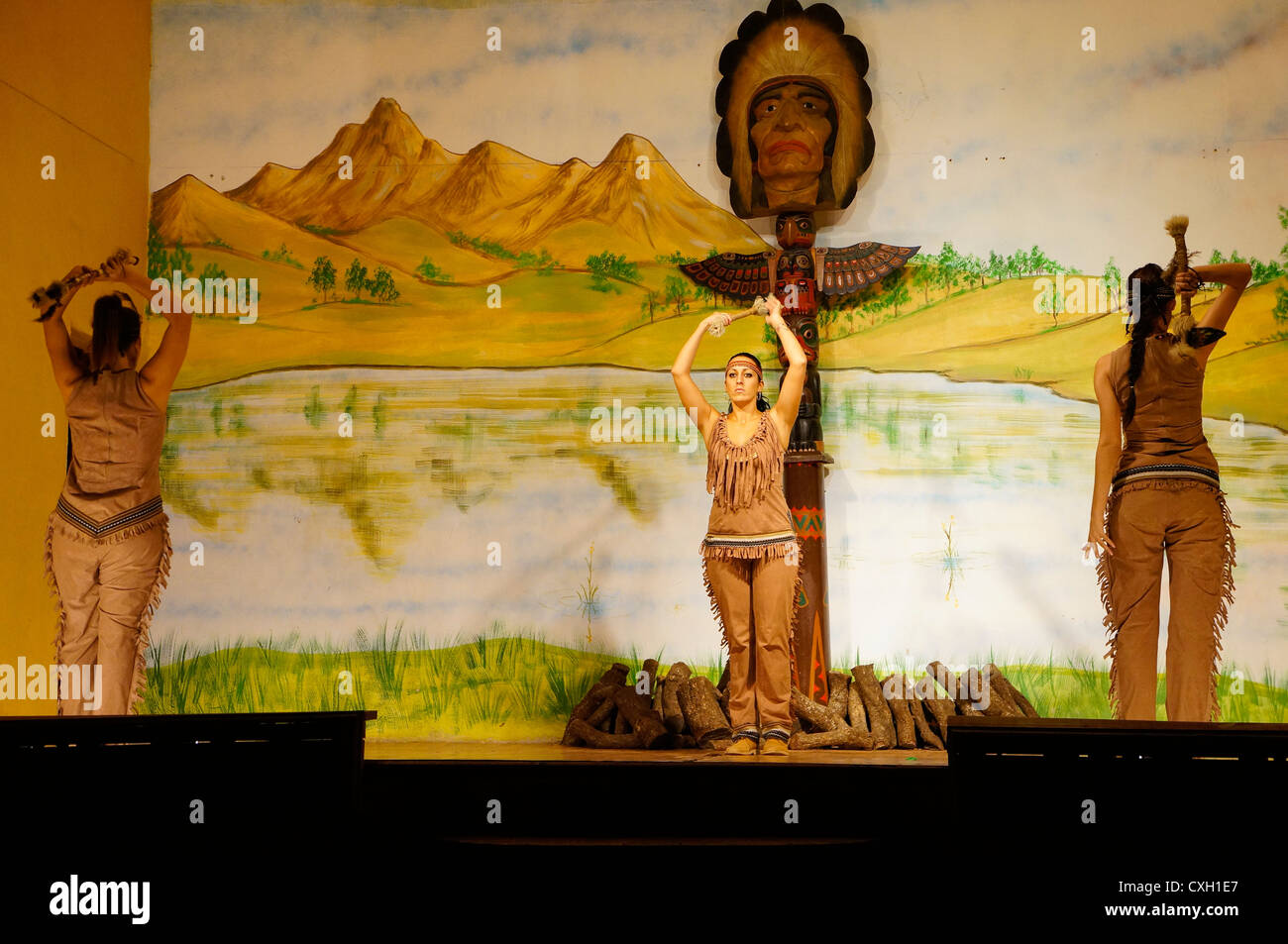Inside of a old wild west saloon. A front view of women singing and ...