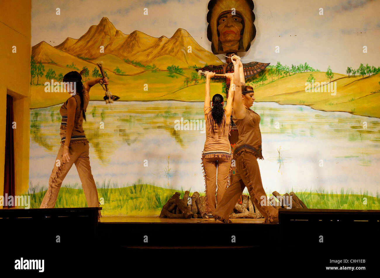 Inside of a old wild west saloon. A front view of women singing and ...