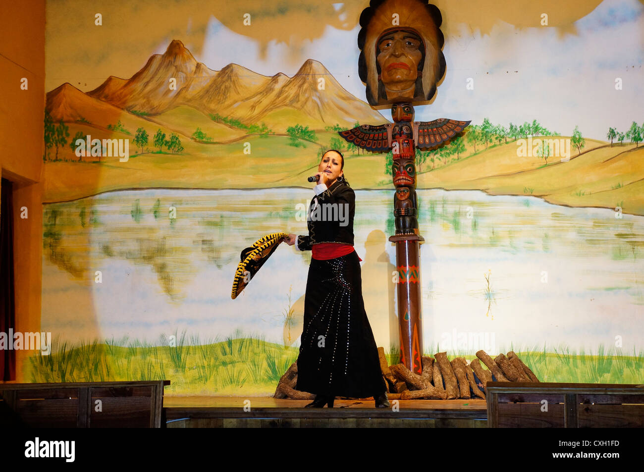Inside of a old wild west saloon. A front view of women singing and ...