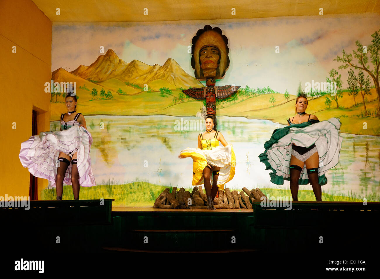 Inside of a old wild west saloon. A front view of women singing and ...
