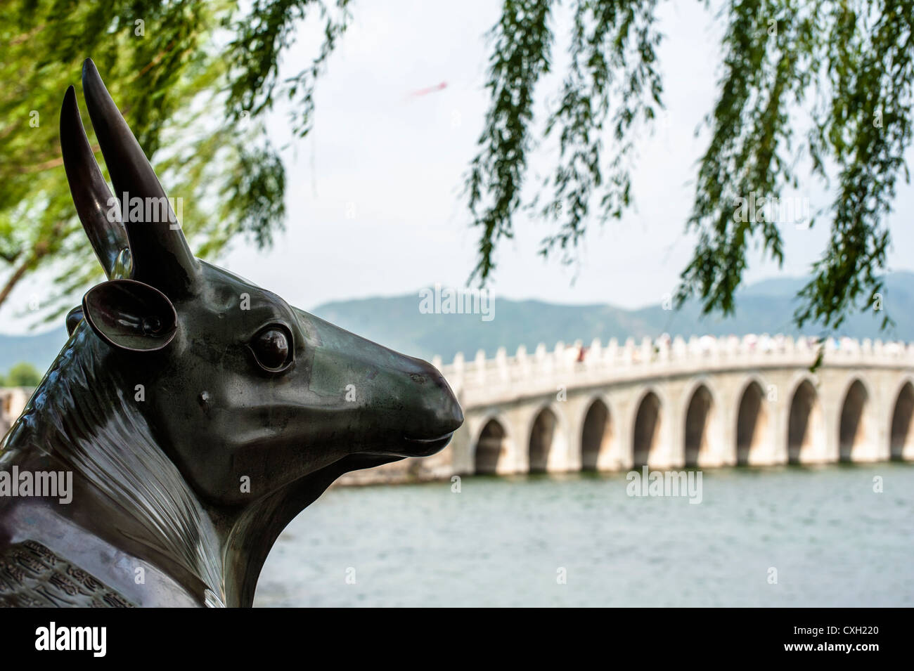 Copper bull and the ancient bridge in Summer Palace Stock Photo - Alamy