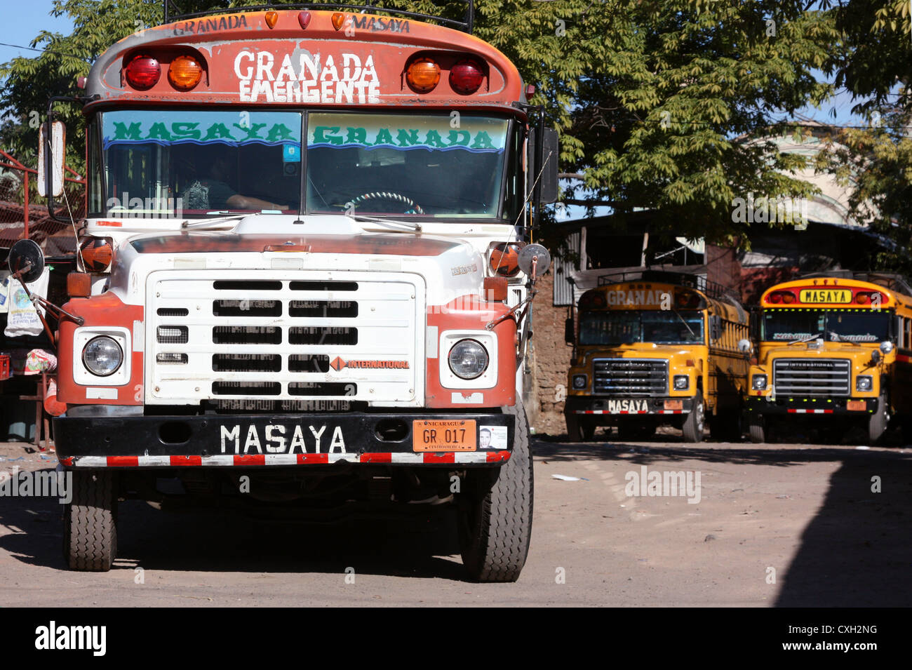 Brightly decorated public buses (chicken buses) at Masaya bus station ...
