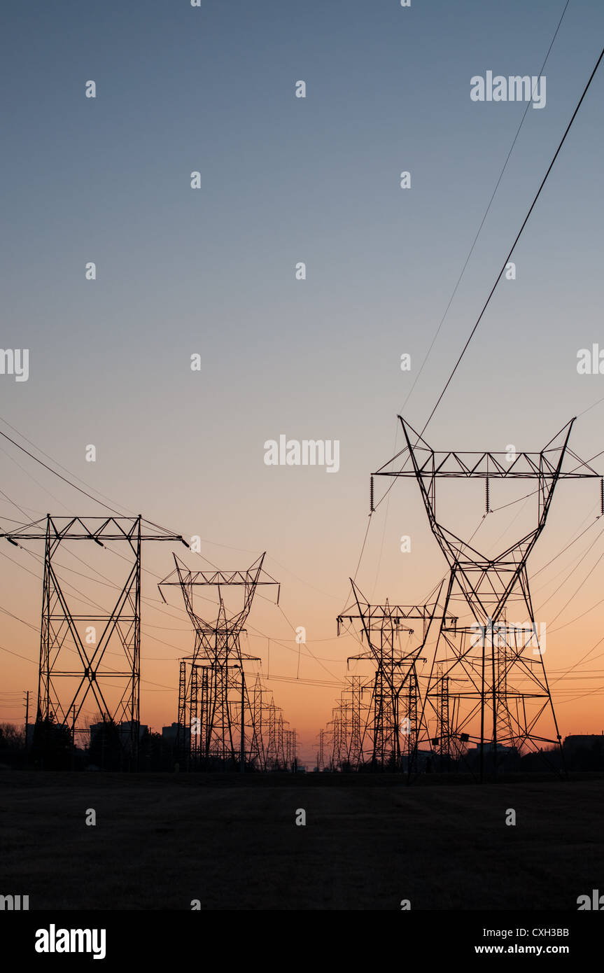A long line of electrical transmission towers carrying high voltage ...
