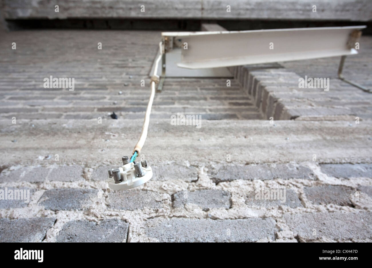electric wire dangling from lamp indoors Stock Photo - Alamy