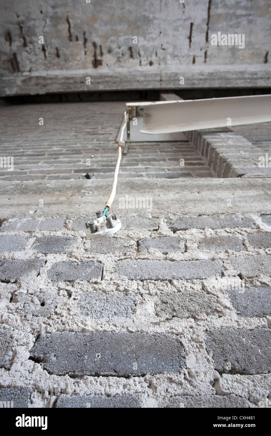 electric wire dangling from lamp indoors Stock Photo - Alamy