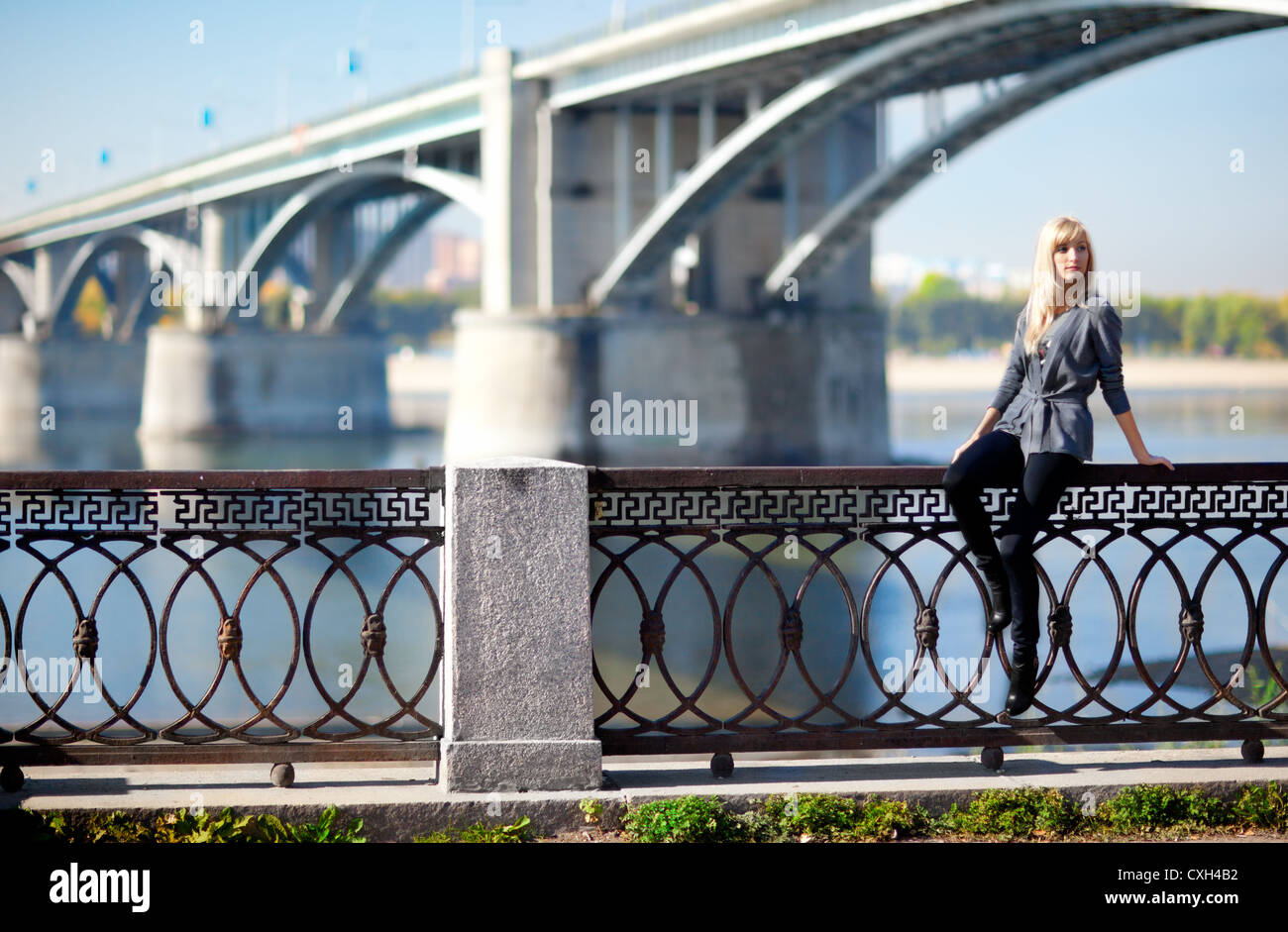 Beautiful woman with bridge on the background Stock Photo - Alamy