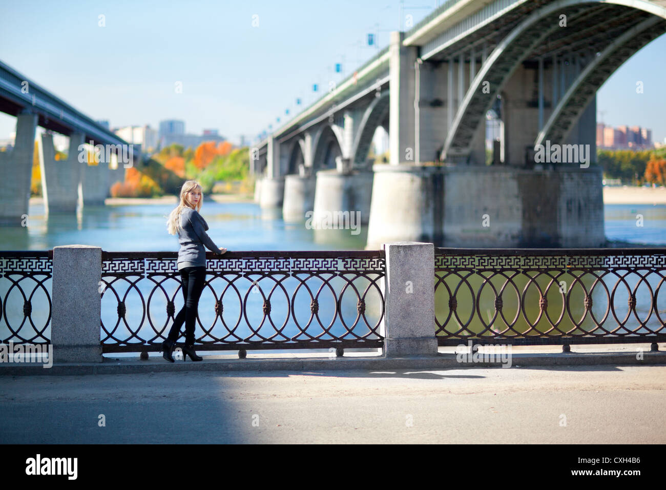 Beautiful woman with bridge on the background Stock Photo - Alamy