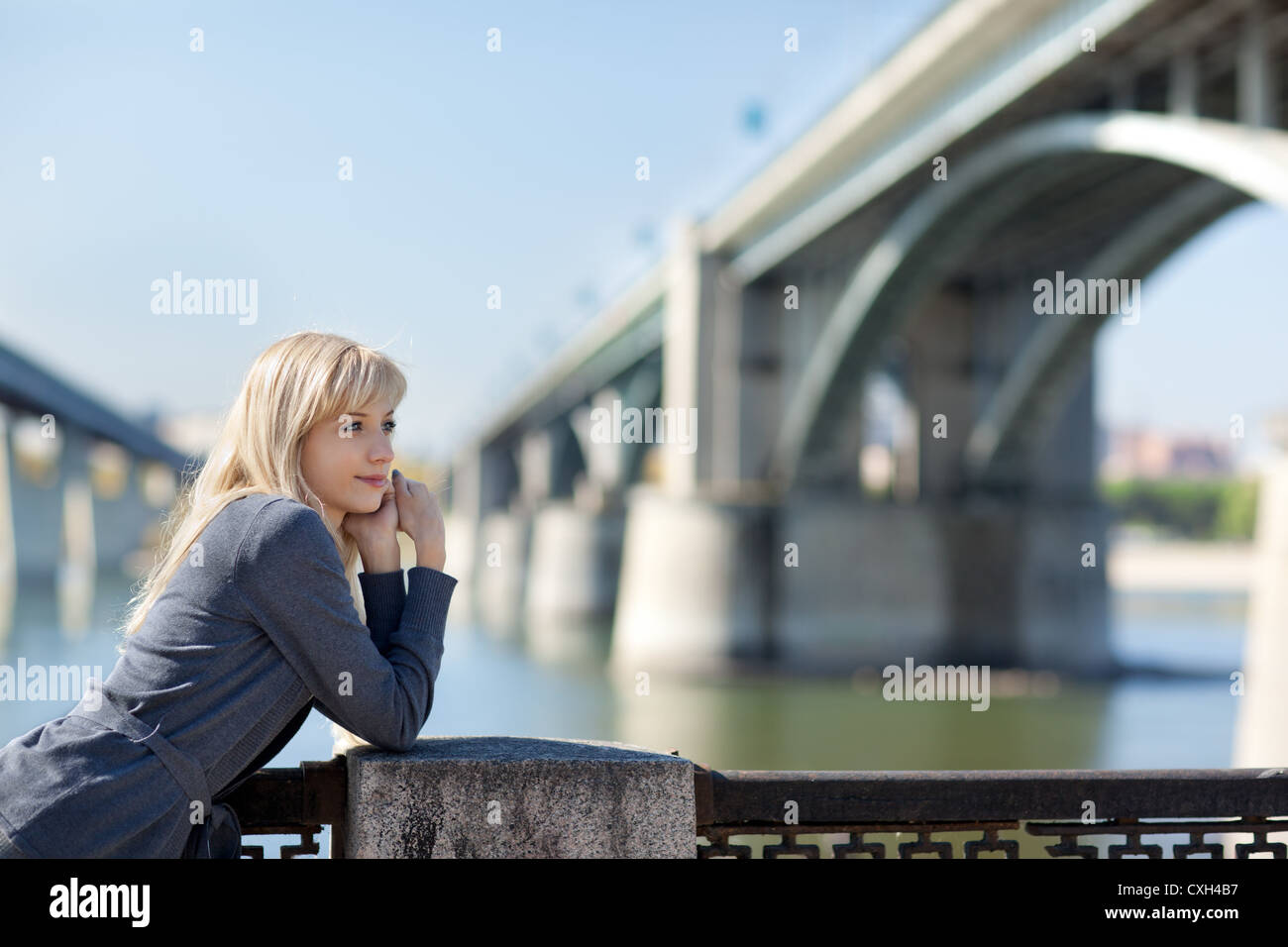 Beautiful woman with bridge on the background Stock Photo - Alamy