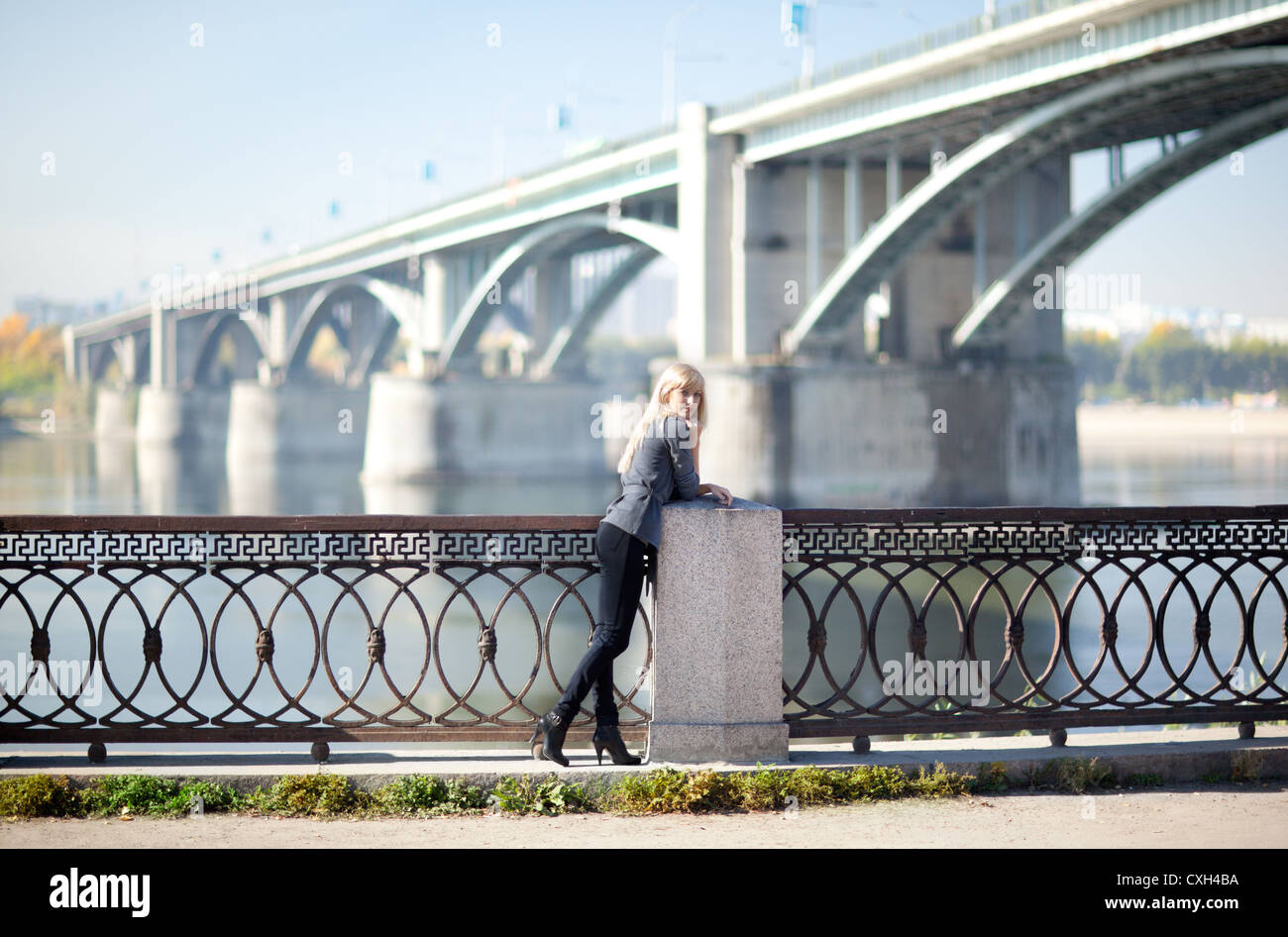 Beautiful woman with bridge on the background Stock Photo - Alamy