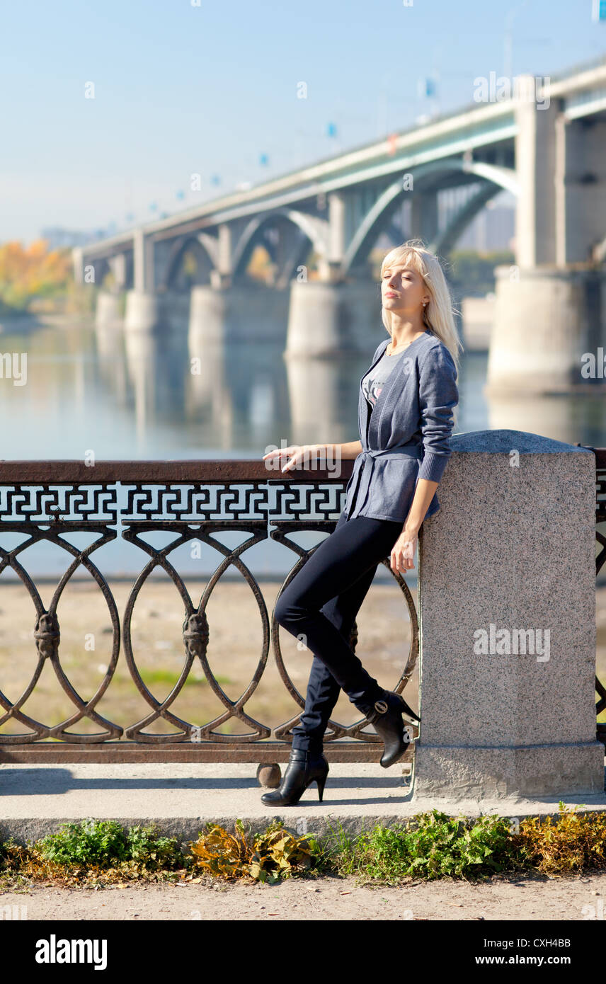 Beautiful woman with bridge on the background Stock Photo - Alamy