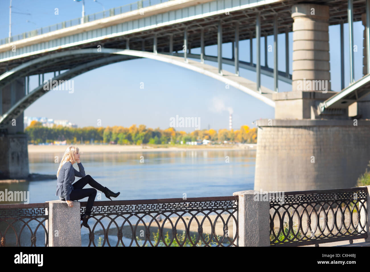 Beautiful woman with bridge on the background Stock Photo - Alamy