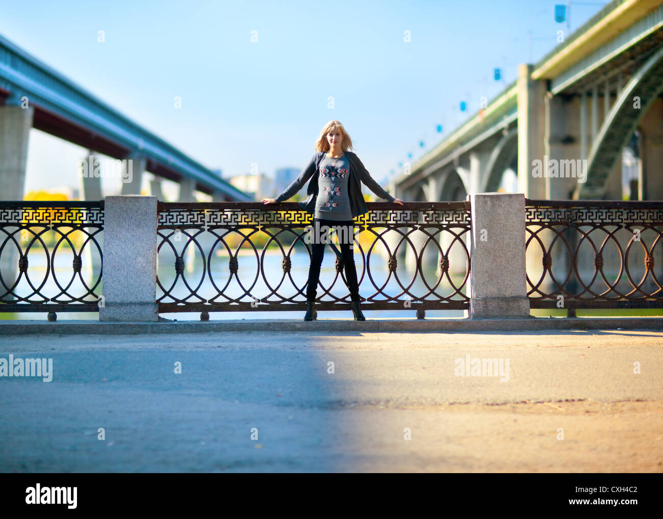 Beautiful woman with bridge on the background Stock Photo - Alamy