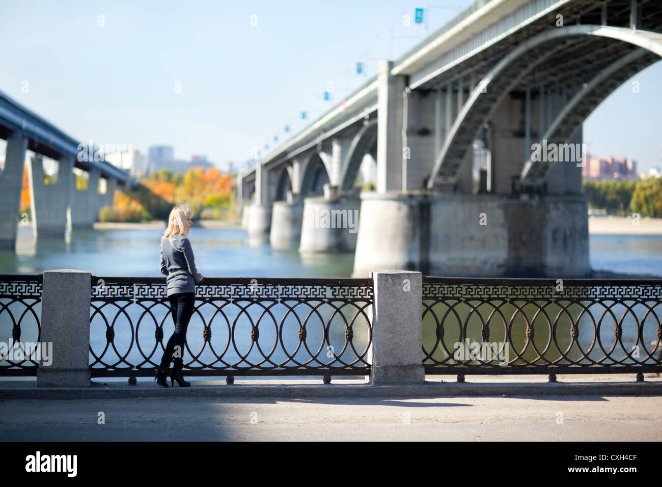 Beautiful woman with bridge on the background Stock Photo - Alamy