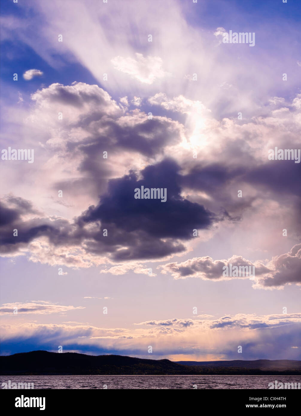 Purple cloudscape sunset seen through dramatic clouds, the Palisades in ...