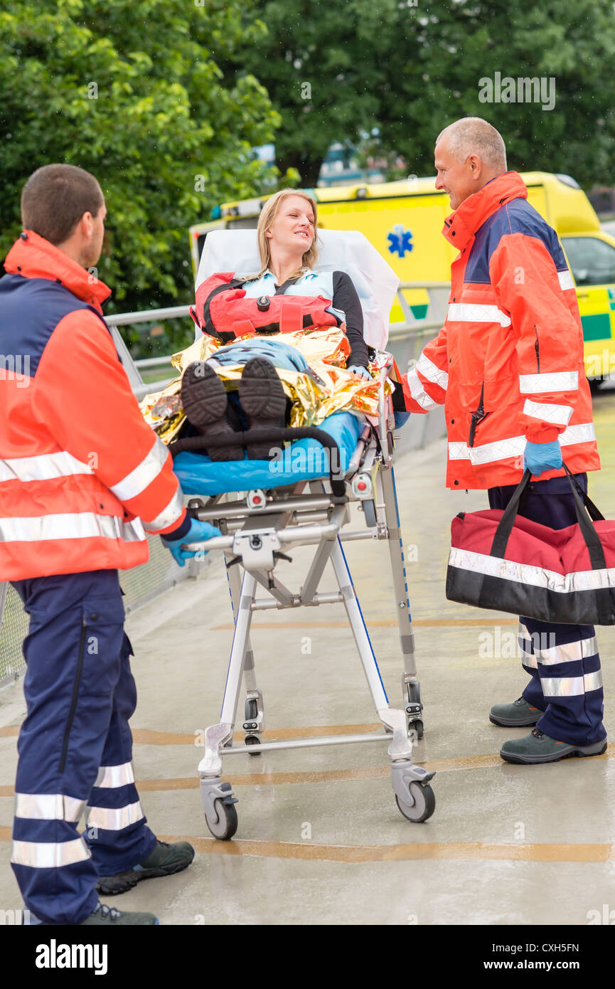 Patient talking with paramedics after accident aid emergency arm injury ...