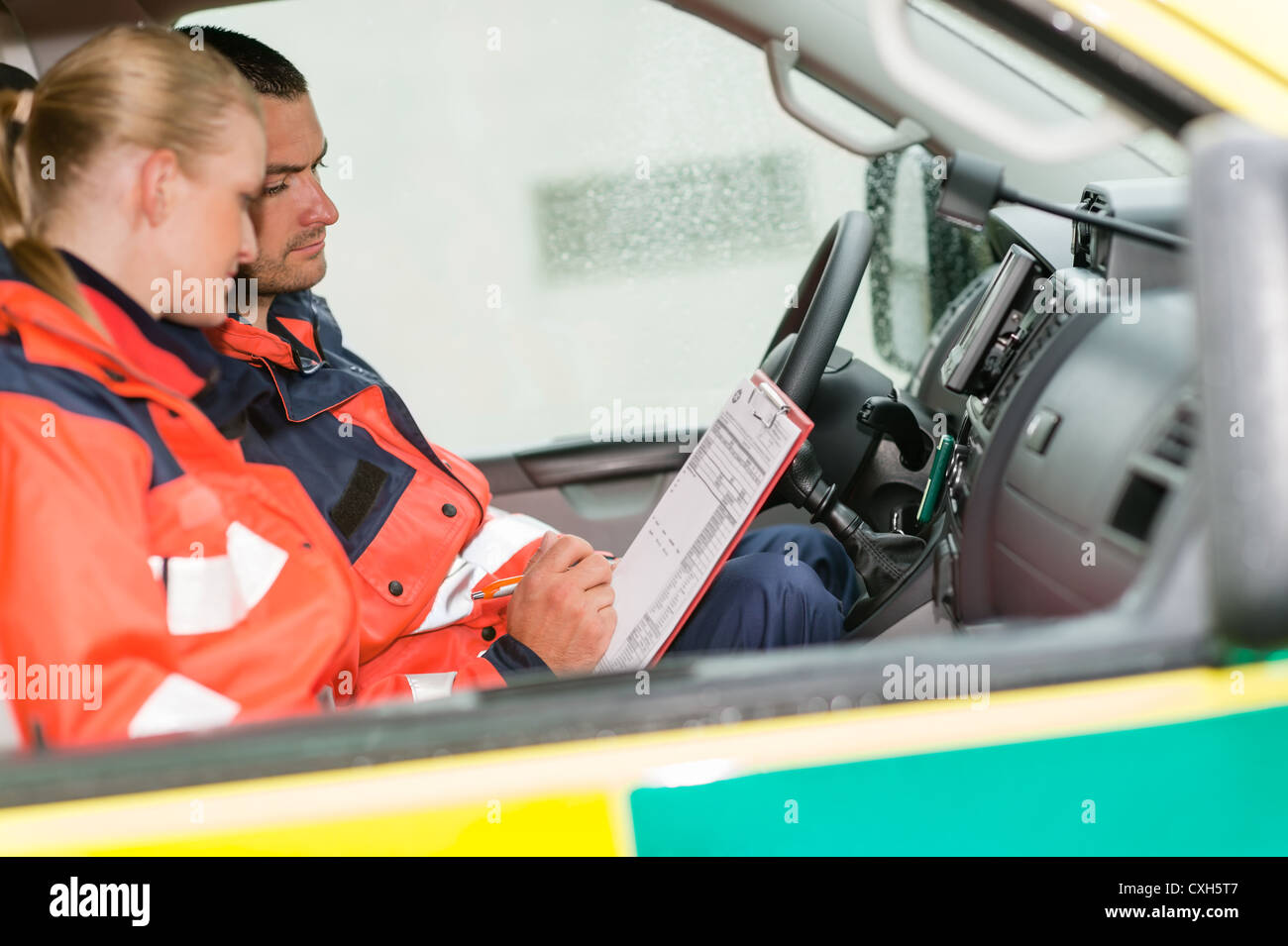 Emergency ambulance car paramedics sitting medical work female doctor ...