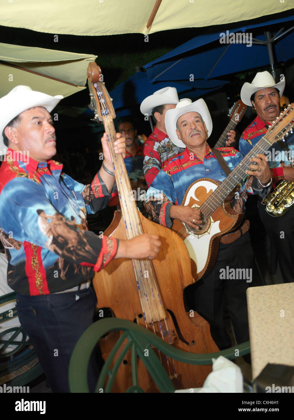 A mariachi band plays for guests at an outdoor restaurant at El Jardin ...