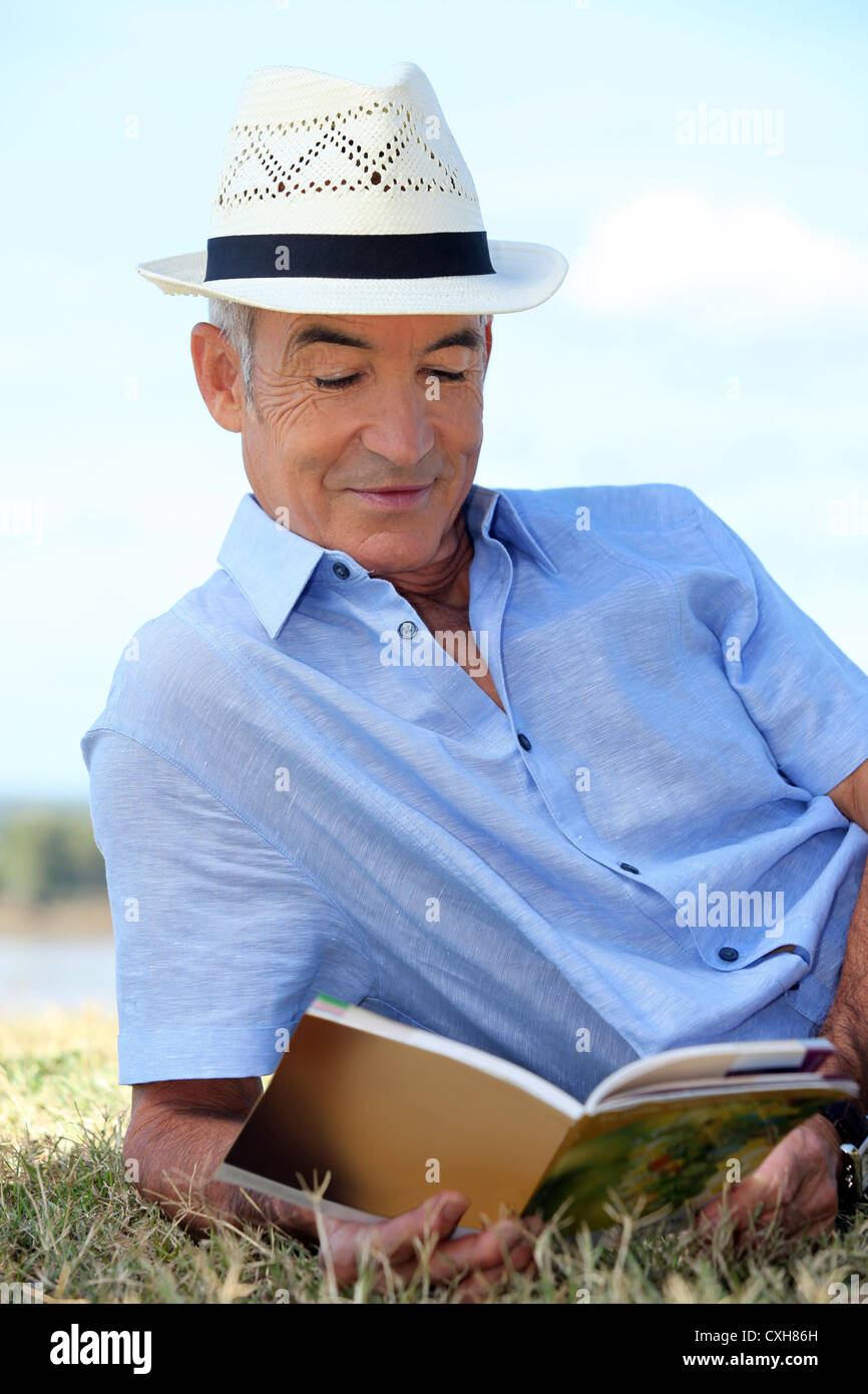 senior reading a book in the park Stock Photo - Alamy