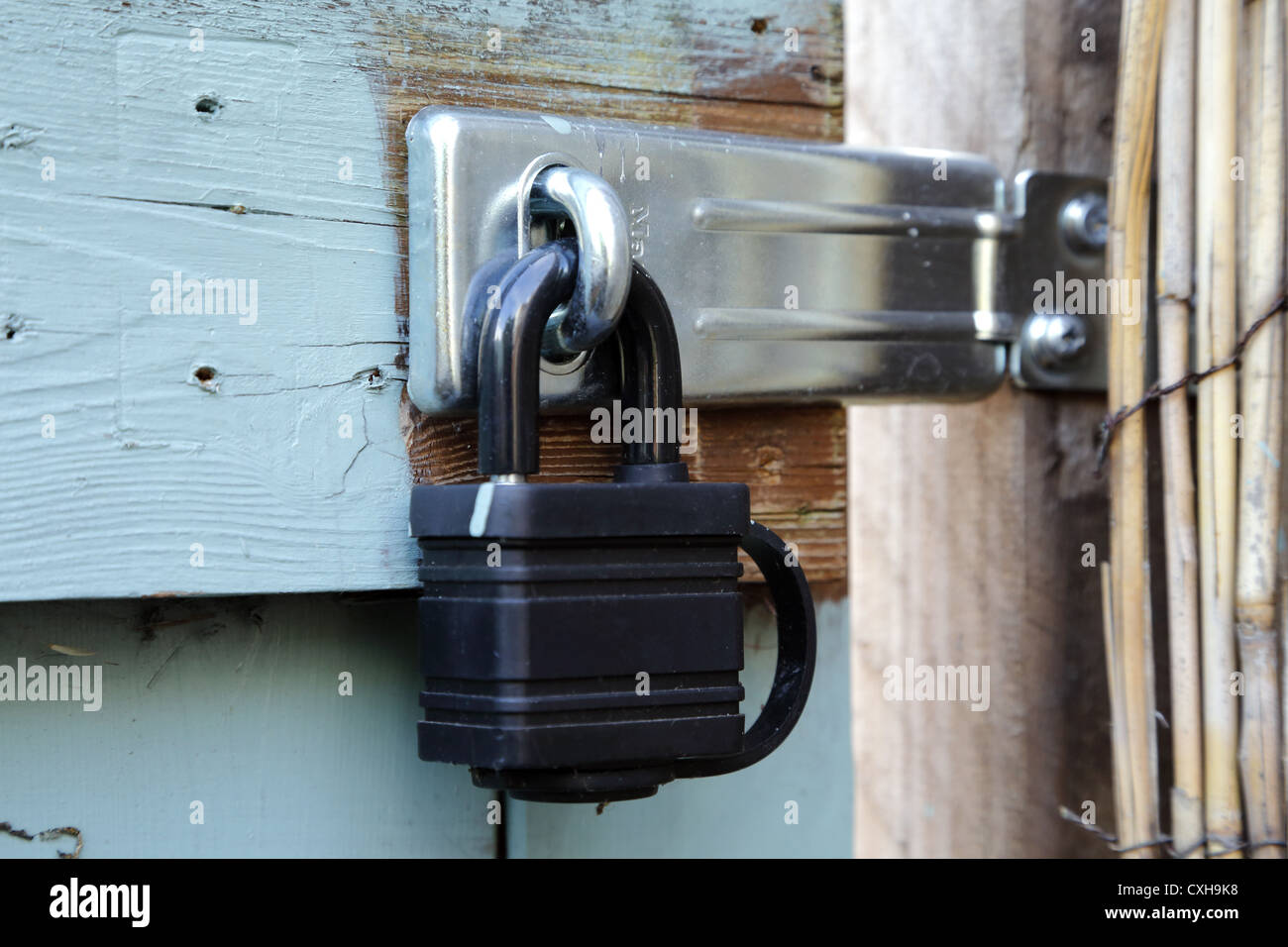 Padlock on a back garden door Stock Photo - Alamy