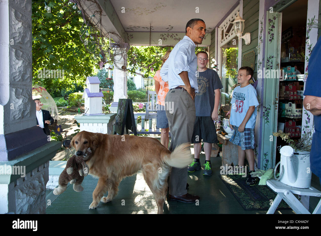 US President Barack Obama talks with people at Grasshoppers store ...