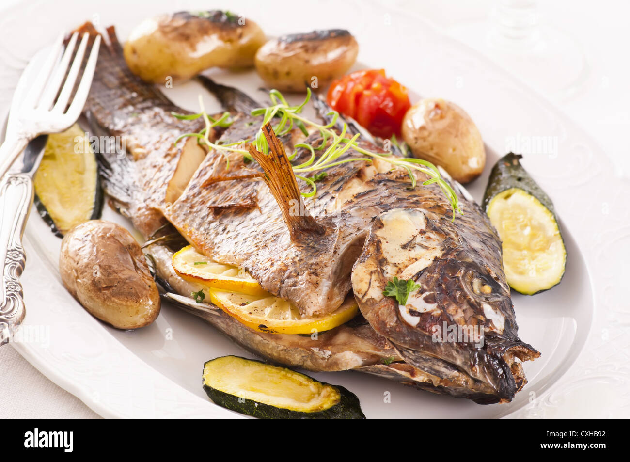Fish roasted with vegetables Stock Photo - Alamy