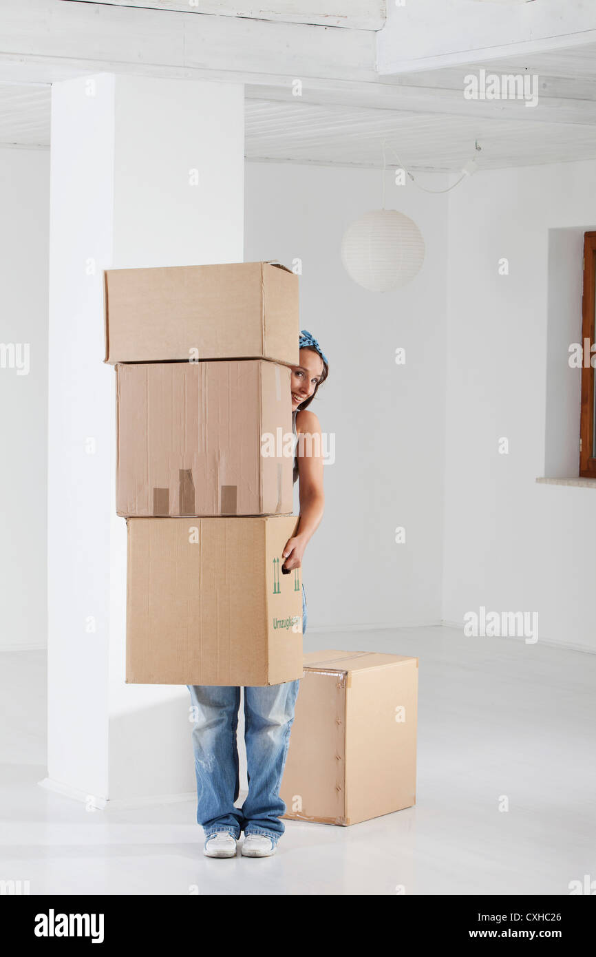 Young woman carrying cardboard boxes Stock Photo - Alamy