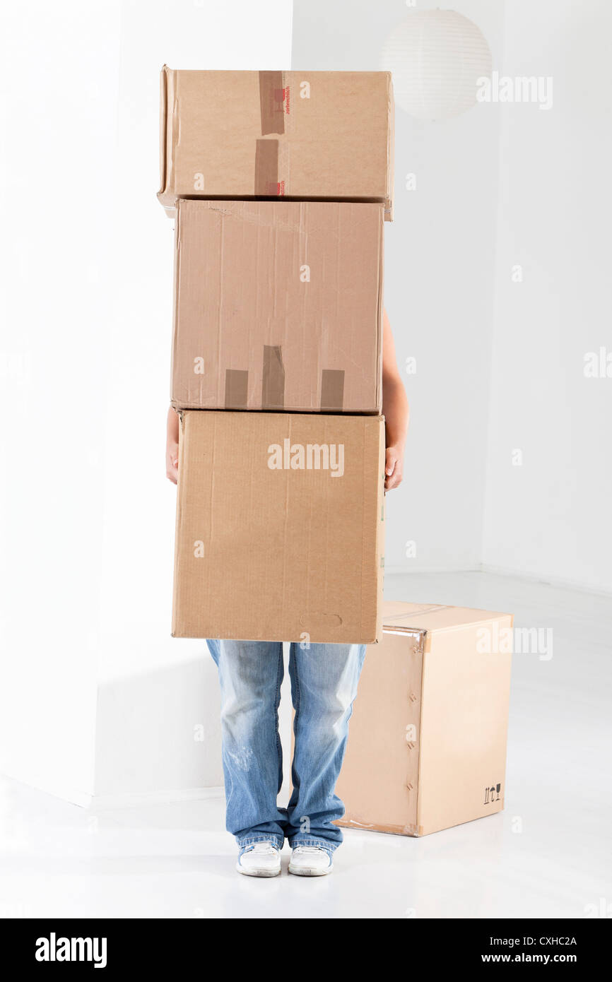 Young woman carrying cardboard boxes Stock Photo - Alamy