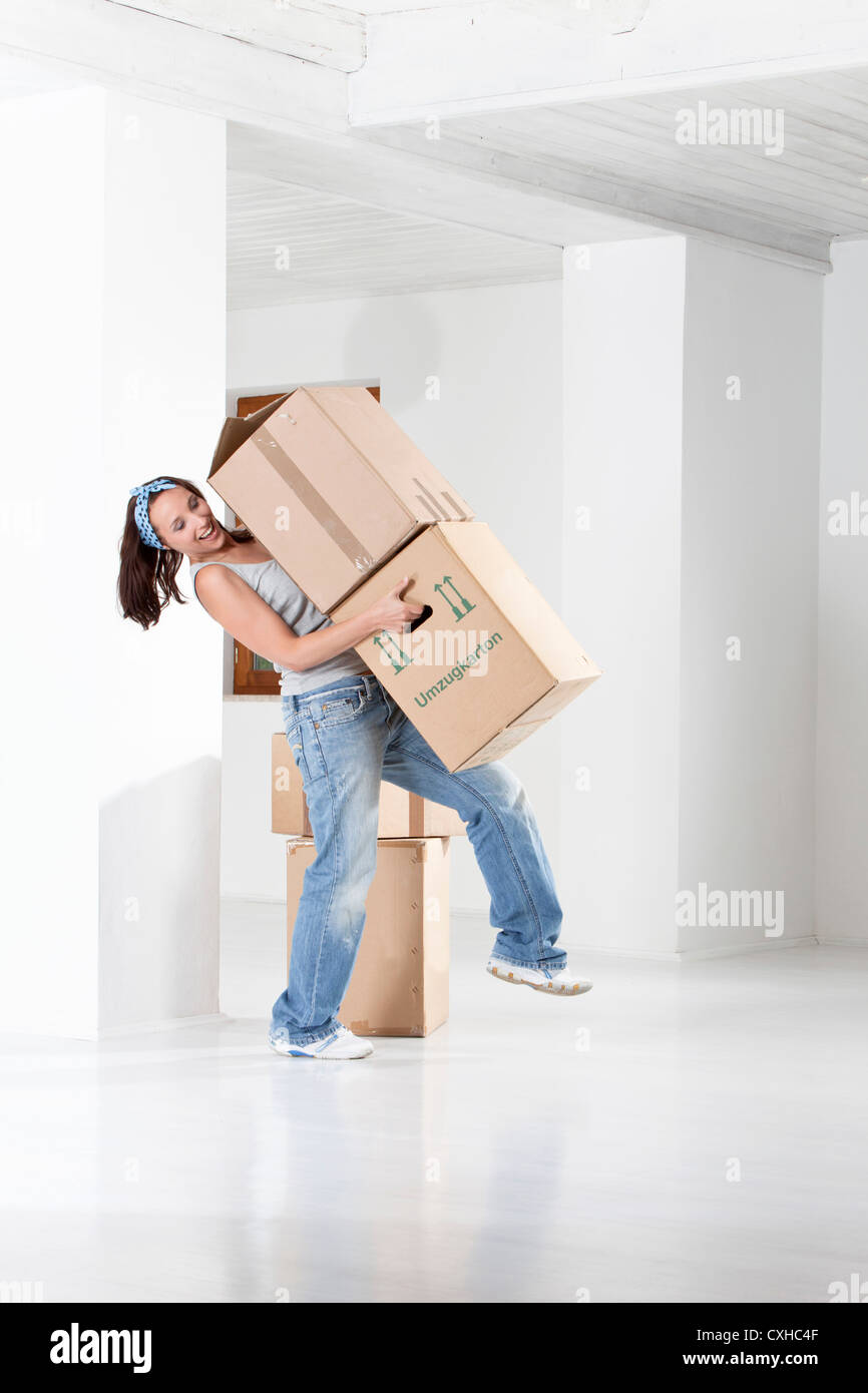 Woman carrying stack of cardboard boxes hi-res stock photography and ...