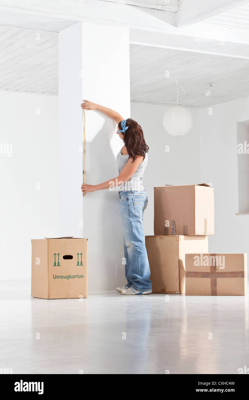 Young woman measuring with folding ruler Stock Photo - Alamy