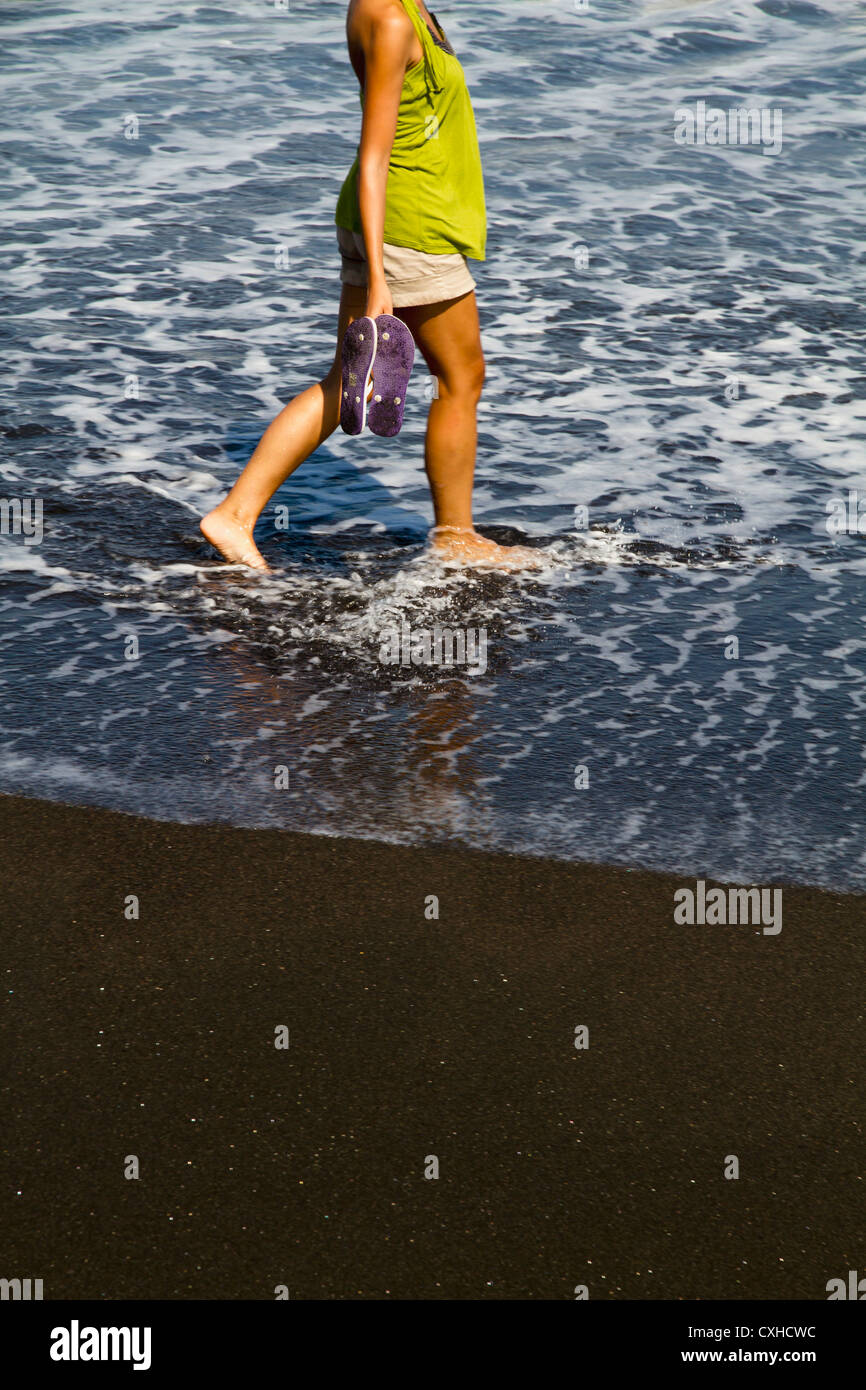 Indonesia, Young woman walking in water Stock Photo - Alamy